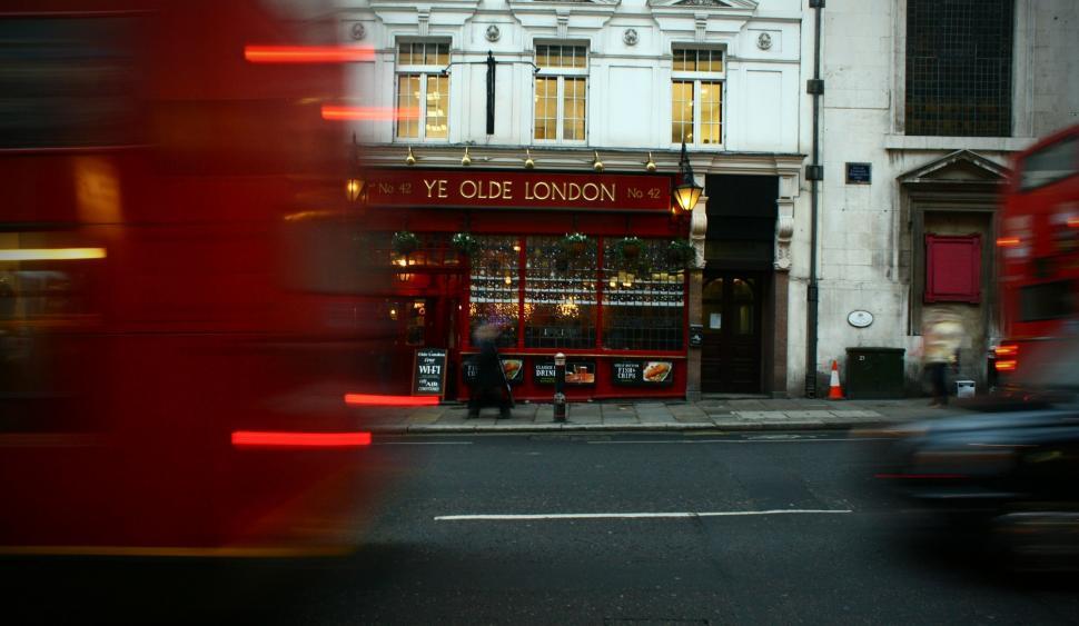 Free Stock Photo of Red Double Decker Bus Passing Tall Building ...