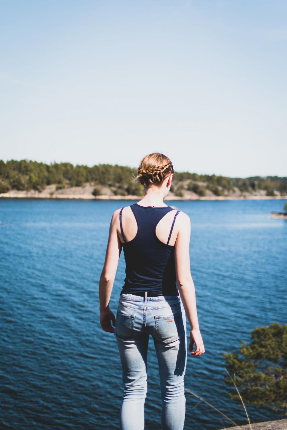 Free Stock Photo of Woman Standing on Cliff Edge Overlooking Water ...