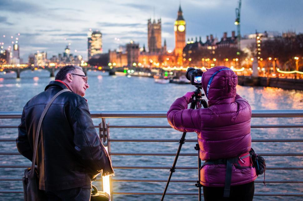 Free Stock Photo of Man and Woman Standing on Bridge With Camera ...
