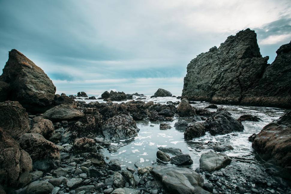 Free Stock Photo of Rocky Beach With Water Body Surrounded by Rocks ...