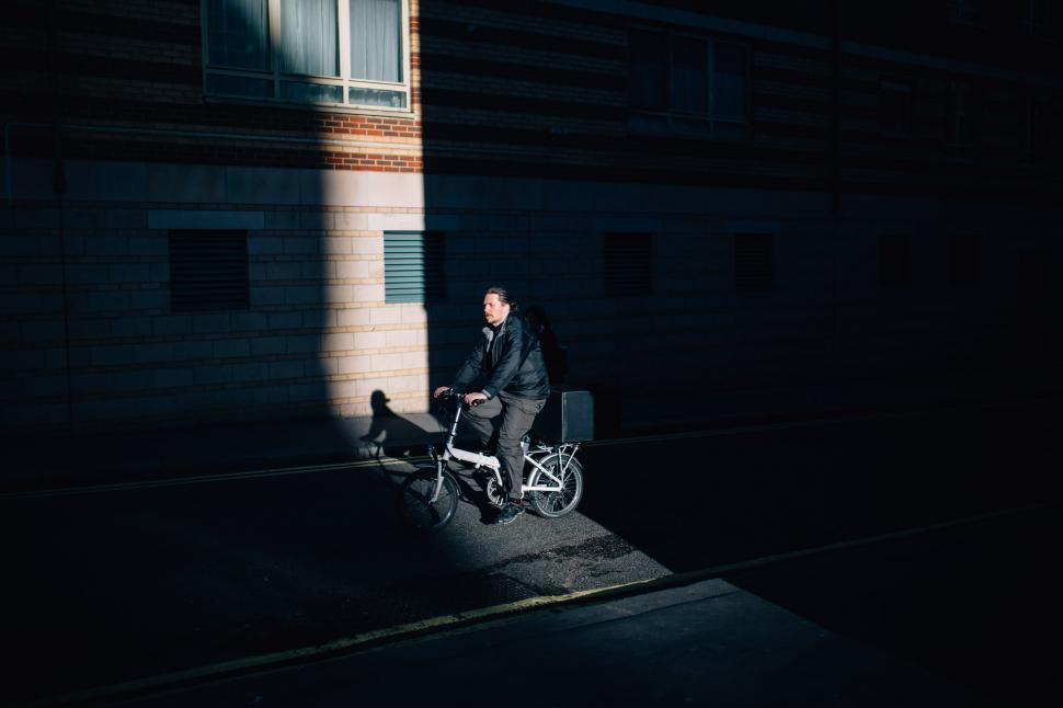 Free Stock Photo of Man Riding Bike Down Dark Street | Download Free ...