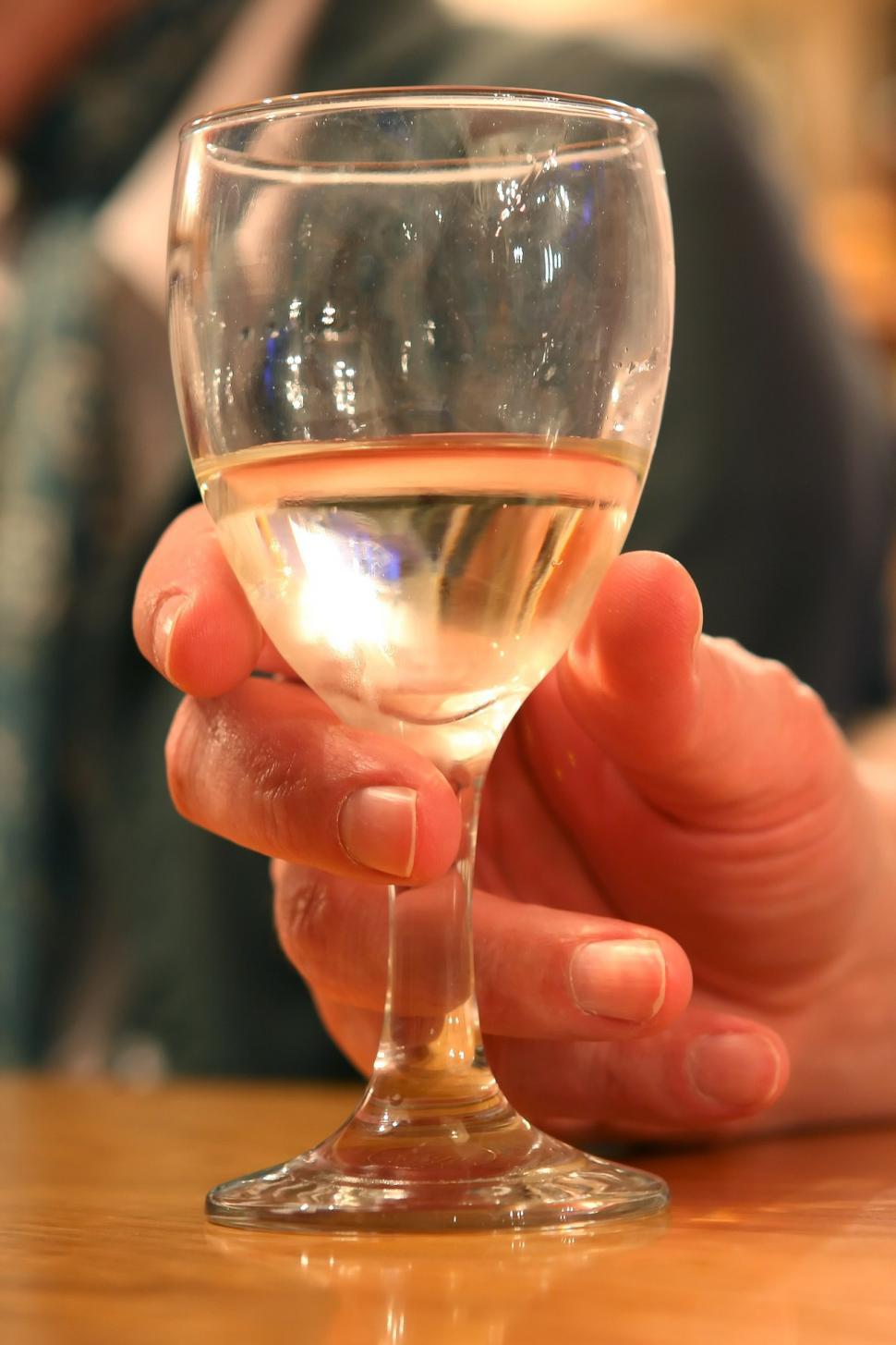 Free Stock Photo of Person Holding Glass of Wine on Table | Download ...