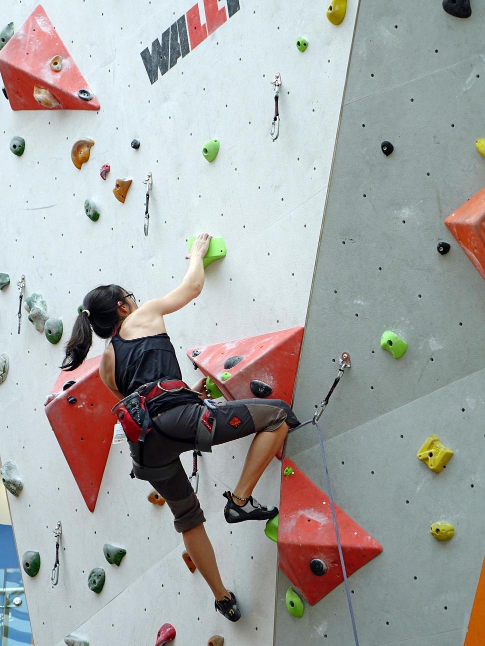 Free Stock Photo of Woman Climbing Up the Side of a Climbing Wall ...