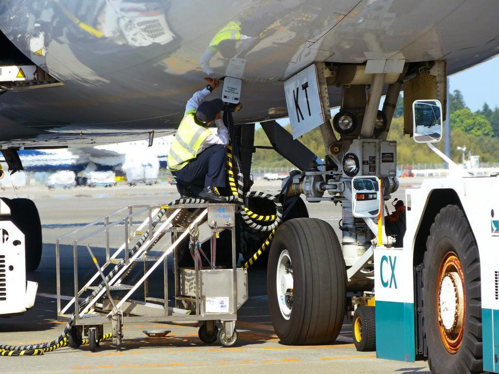 Free Stock Photo of Man Working on Large Airplane on Tarmac | Download ...