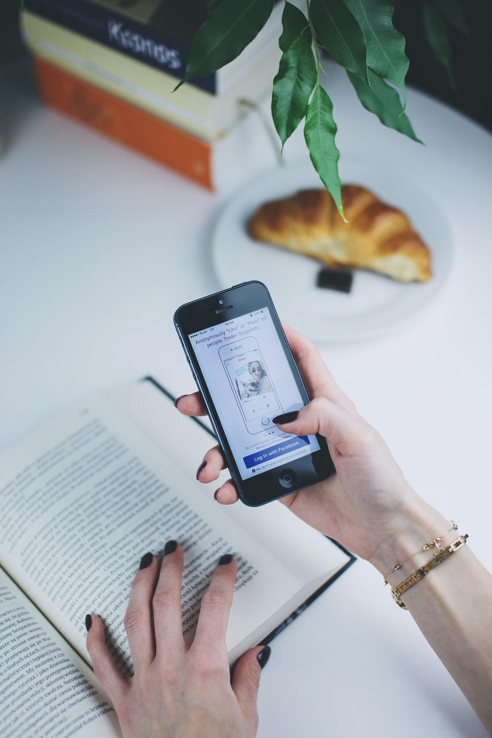 Free Stock Photo of Person Holding Cell Phone and Reading Book ...