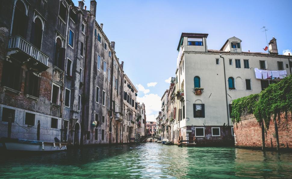 Free Stock Photo of River Flowing Through Urban Landscape With Tall ...
