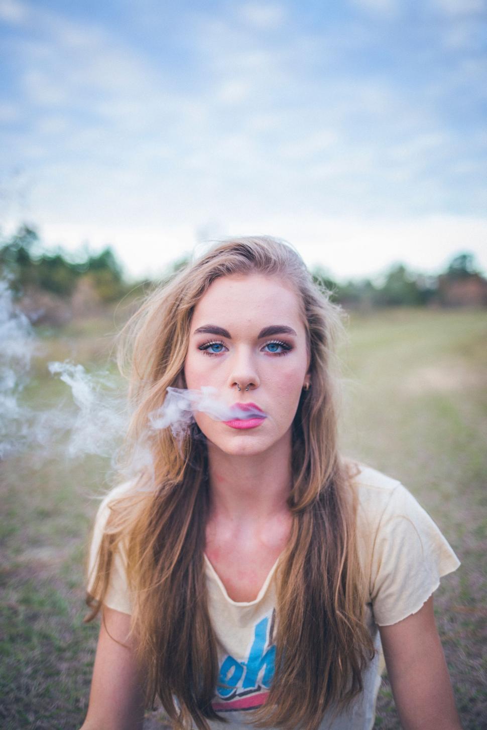 Free Stock Photo of Woman Sitting on Ground Smoking a Cigarette ...