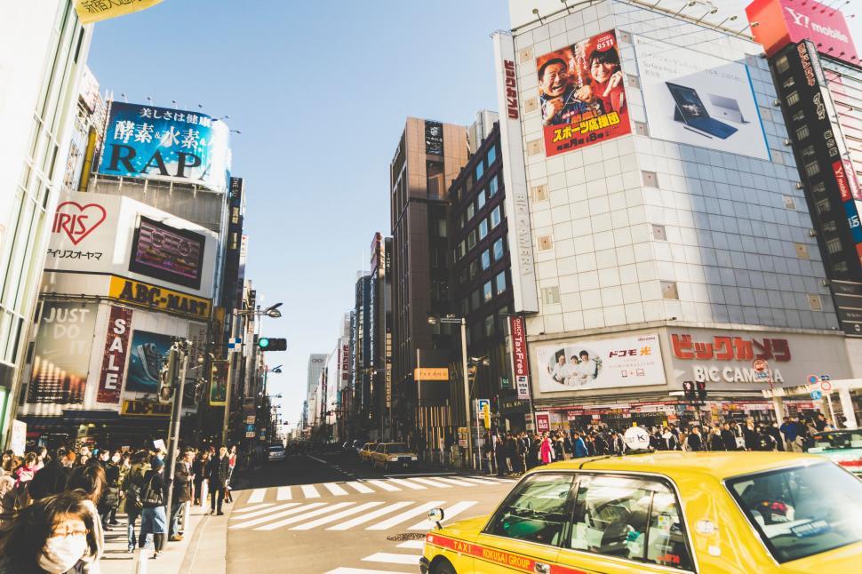 Free Stock Photo of Yellow Taxi Cab Driving Down Busy City Street ...
