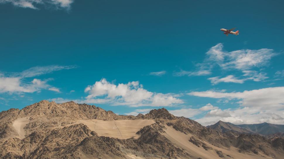 Free Stock Photo of Plane Flying Over Mountain Range in Blue Sky ...
