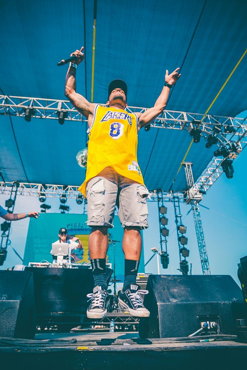 Free Stock Photo of Man Standing on Stage With Hands Raised | Download ...