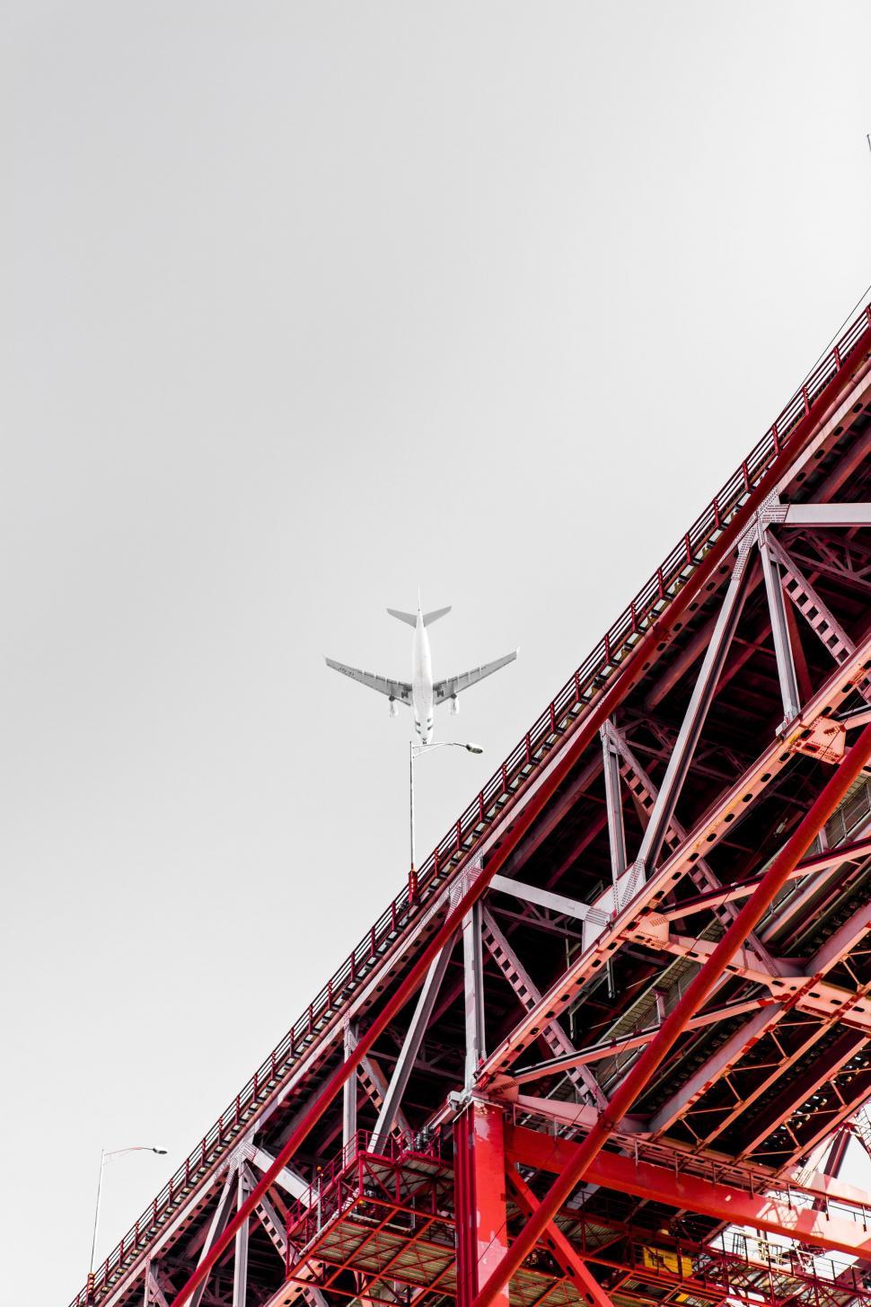 Free Stock Photo of Airplane Flying Over Red Bridge | Download Free ...
