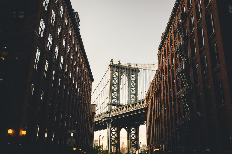Free Stock Photo of Tall Bridge Towering Over City Next to Tall ...