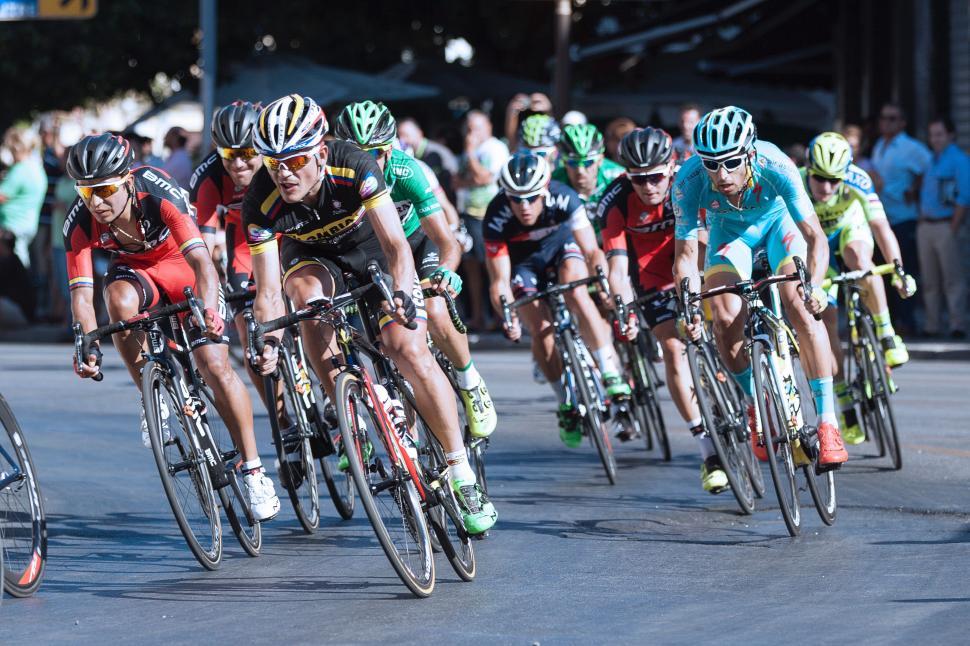 Free Stock Photo of Group of People Riding Bikes Down a Street ...